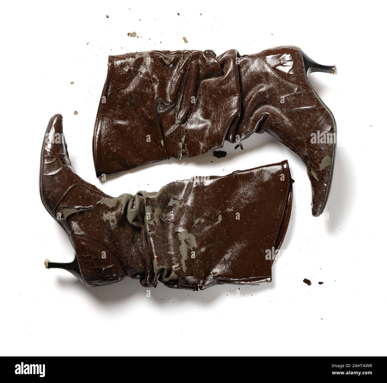 top view pair of badly broken high-heeled shoes on white background ...