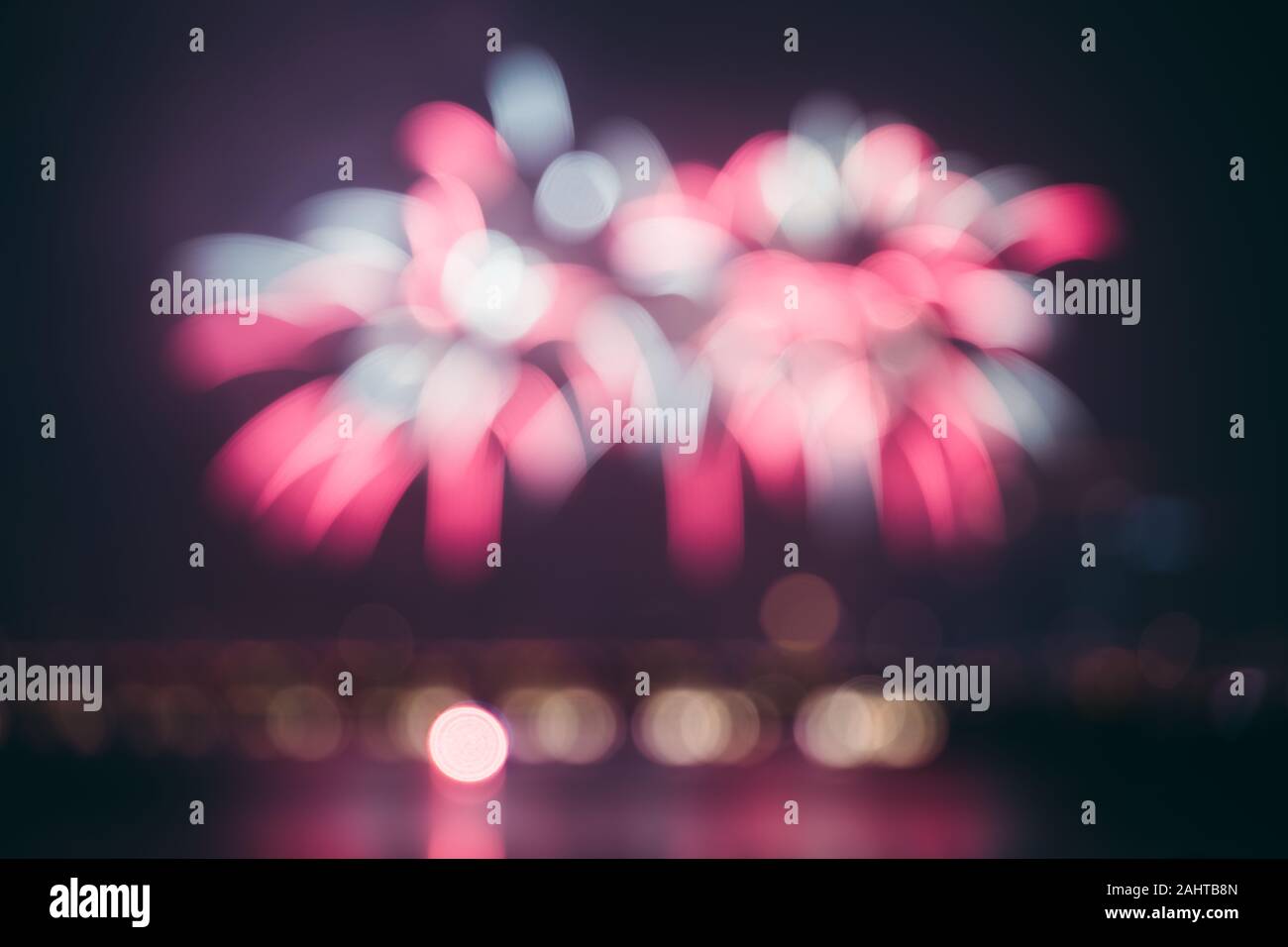 fireworks show in a modern city at blurred focus as background ...