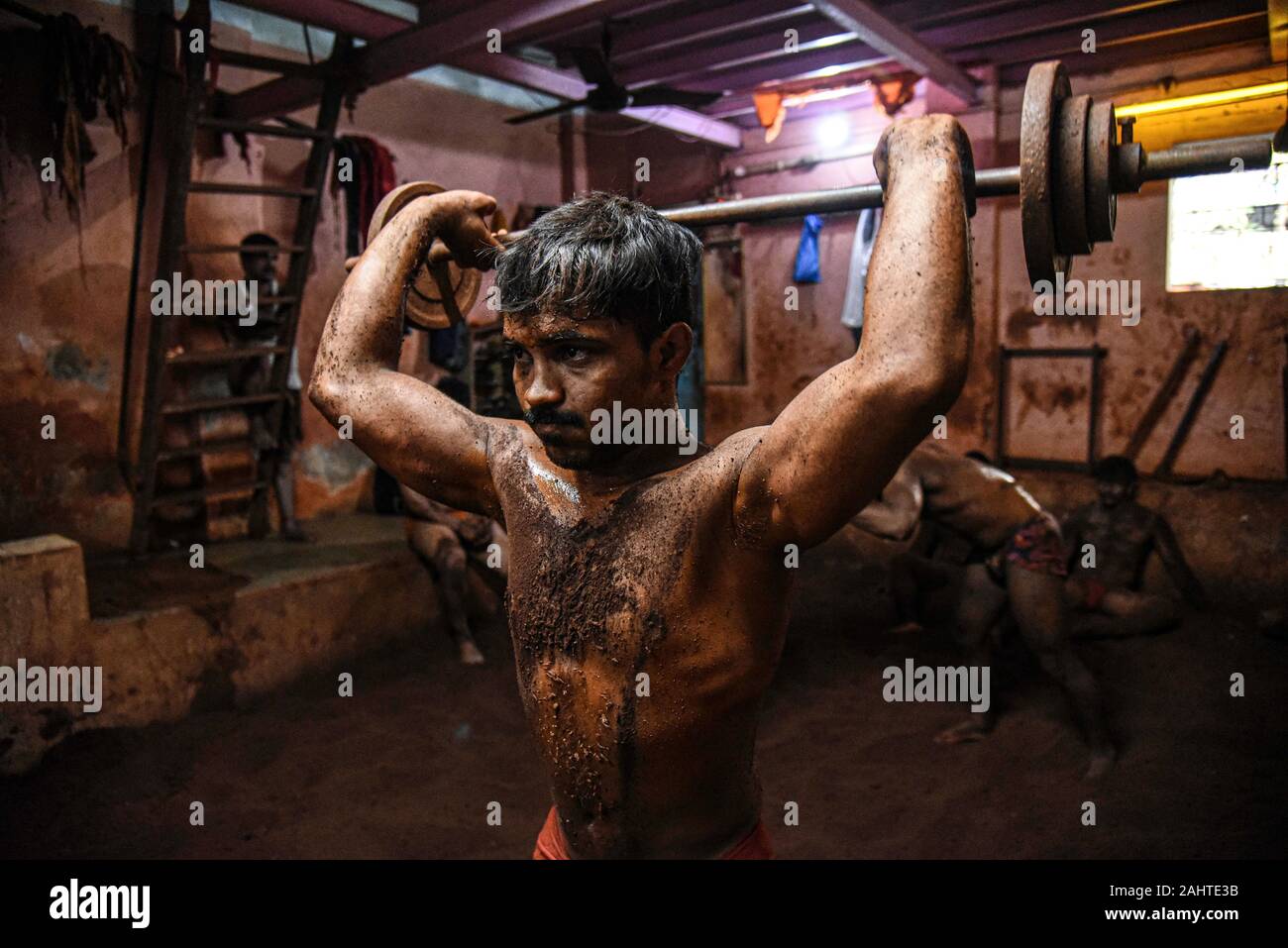 Mumbai, India. 1st Jan, 2020. An Indian wrestler lifts barbell during a ...