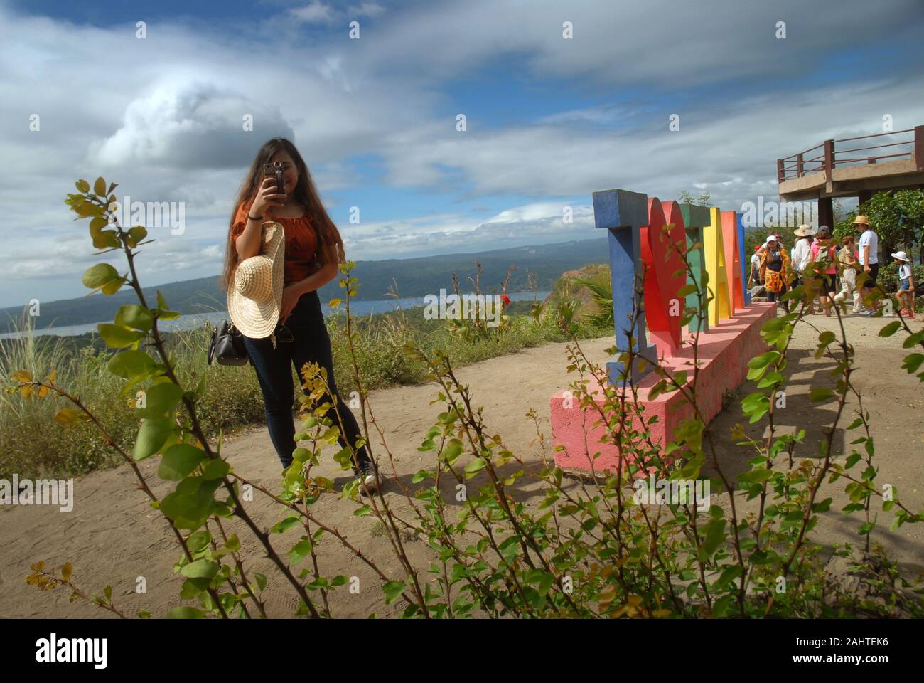 Tourists with the I Love Taal sign at the top of Taal Volcano, Talisay ...