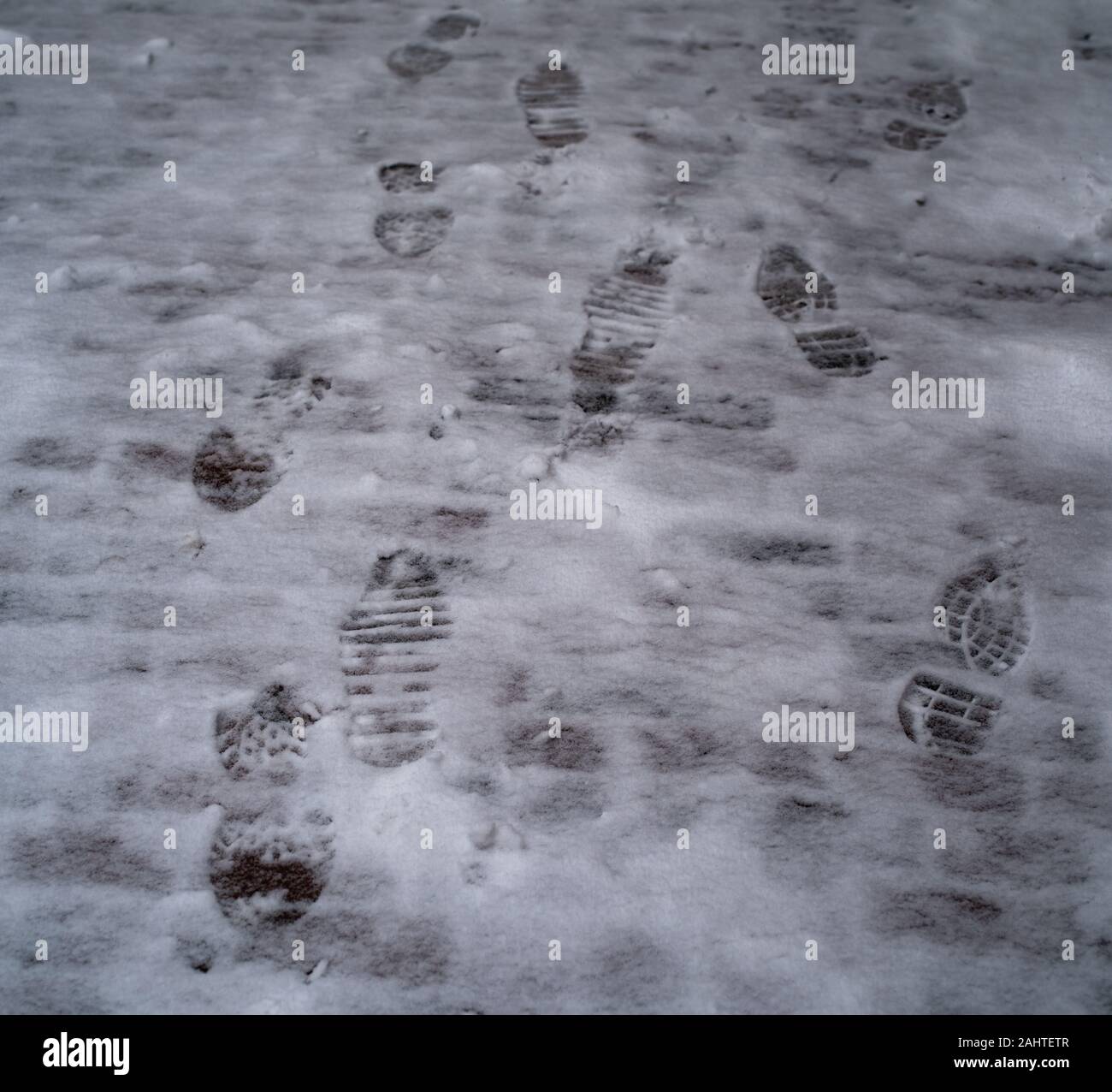 Footprints After a Light Snowfall In The City Stock Photo - Alamy