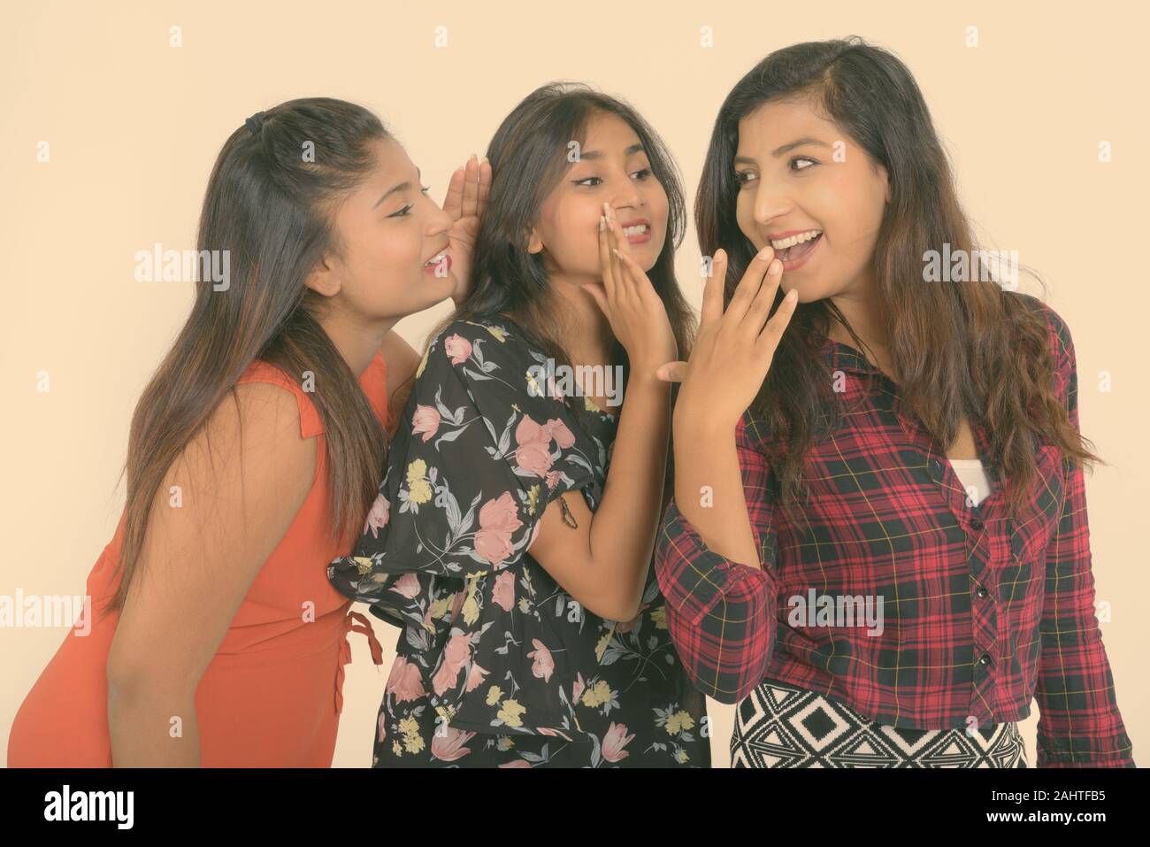 Studio shot of three young beautiful Persian women as friends together ...