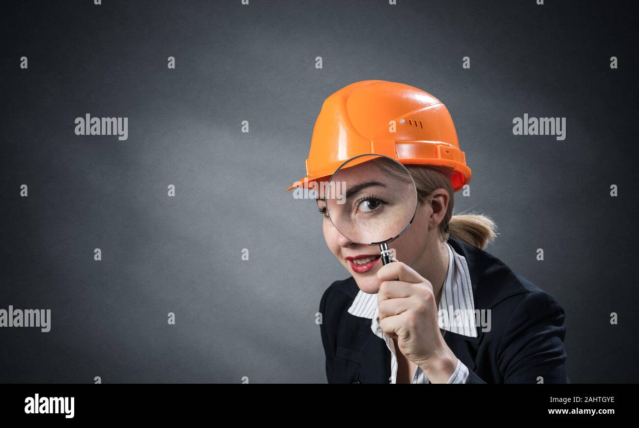 Technical inspector looking through magnifying glass. Woman civil ...