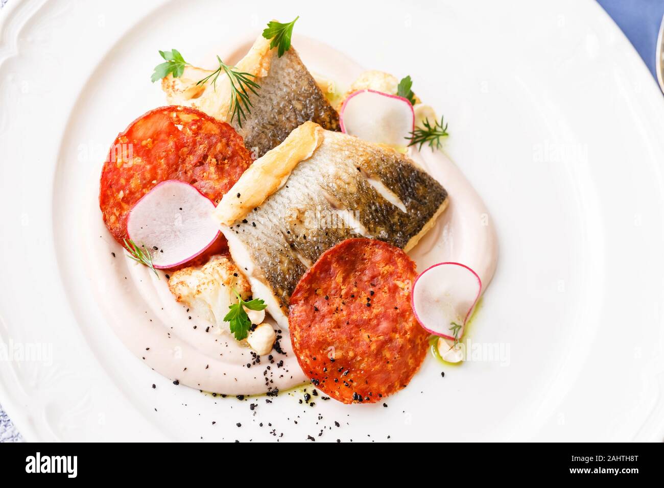 Pike perch fillet with chorizo, cauliflower and radish in a restaurant ...