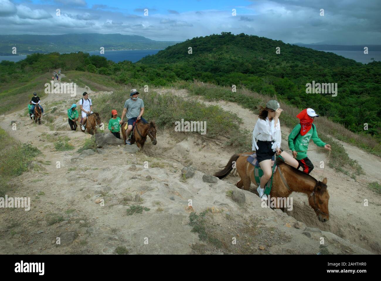 Horses carry Korean tourists up to the top of Taal Volcano, Talisay ...