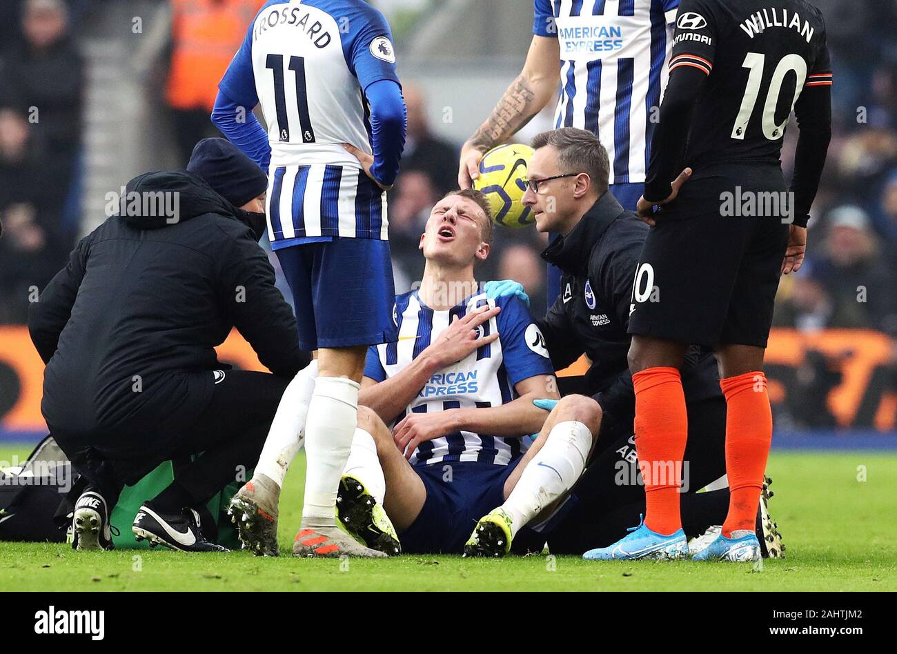 Brighton and Hove Albion's Dan Burn receives treatment before being ...