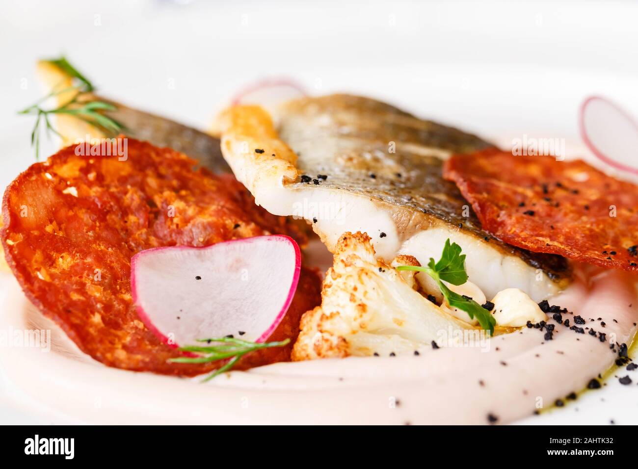 Pike perch fillet with chorizo, cauliflower and radish in a restaurant ...