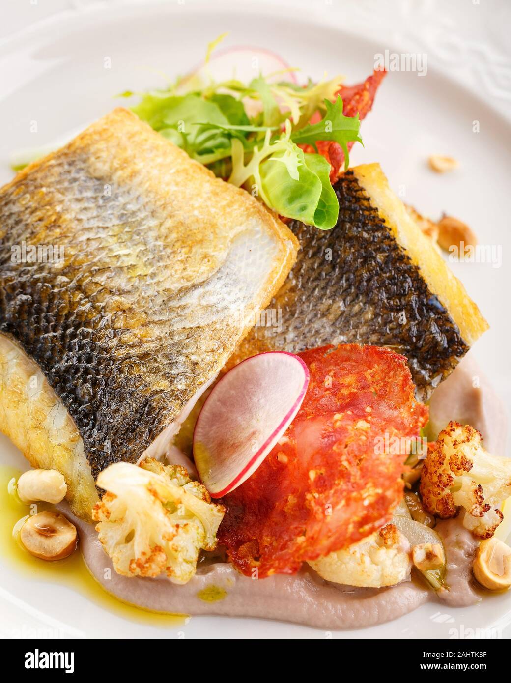 Pike perch fillet with chorizo, cauliflower and radish in a restaurant ...