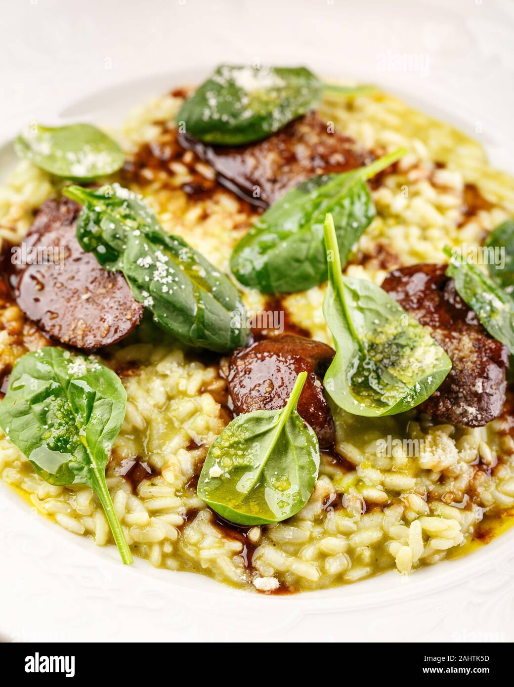 Risotto with spinach and chicken liver garnished with spinach leaves ...