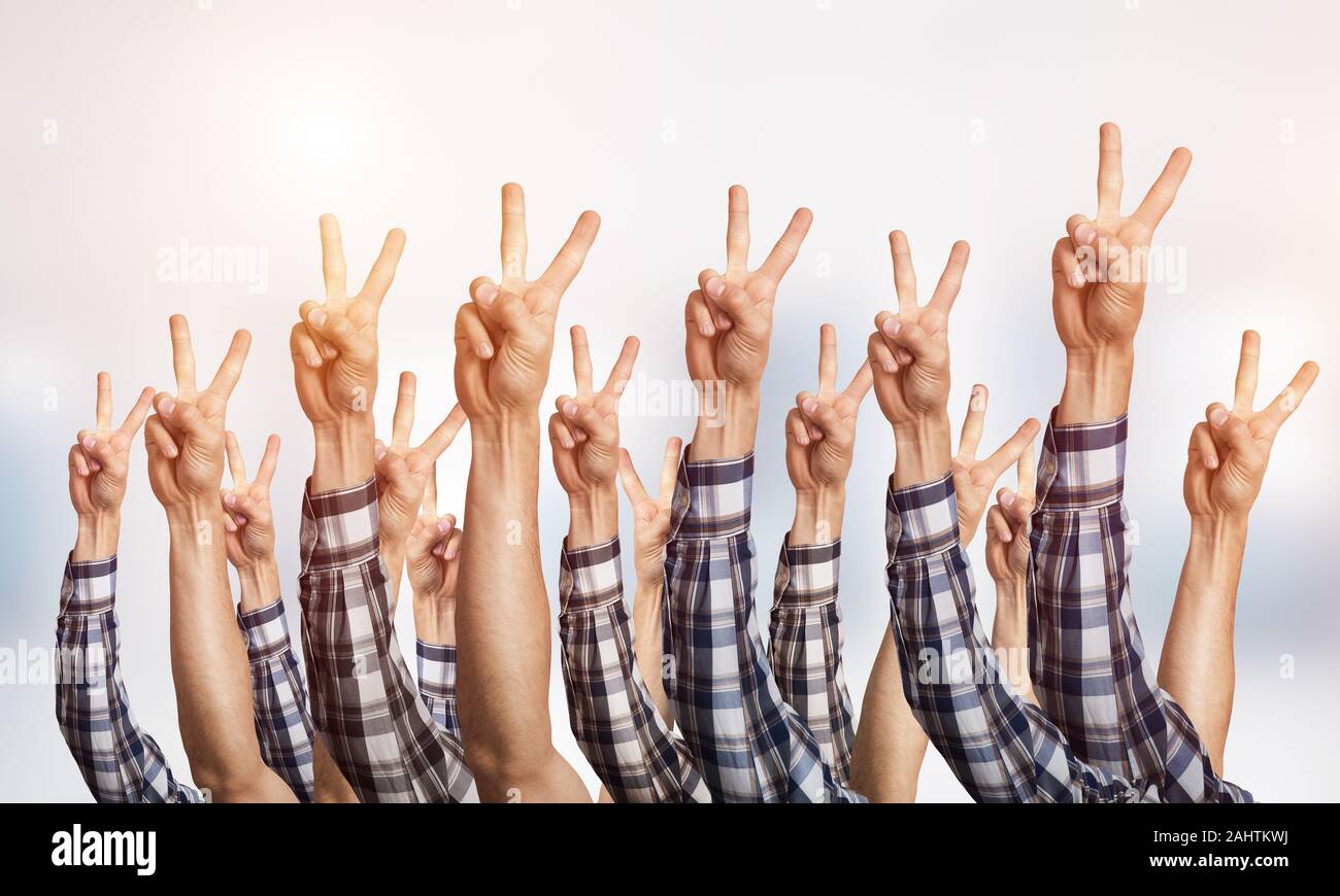 Row of man hands showing victory gesture. Winning or triumph group of ...