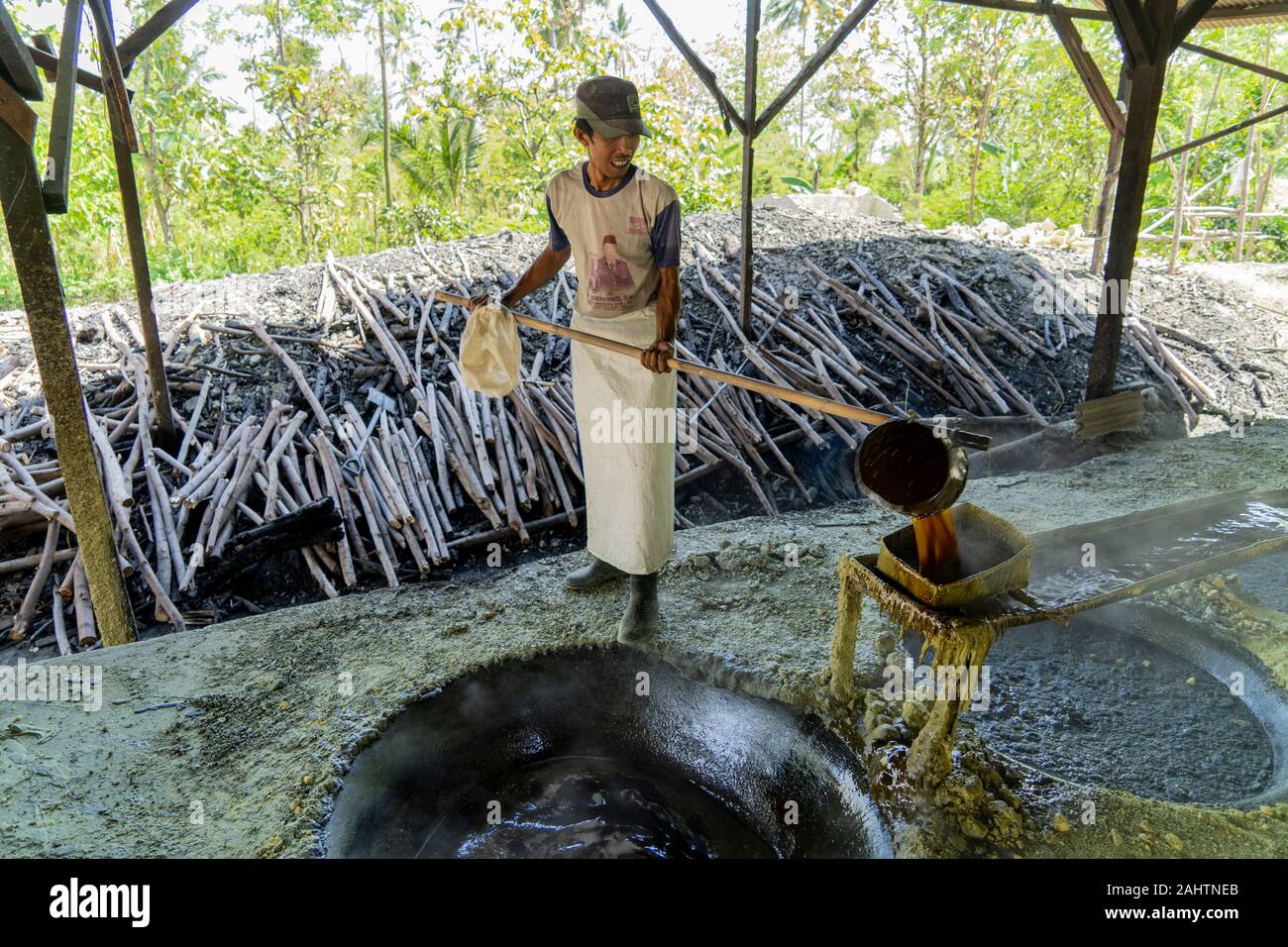Liquid sulphur is poured through a filter in a sulphur factory deep in ...