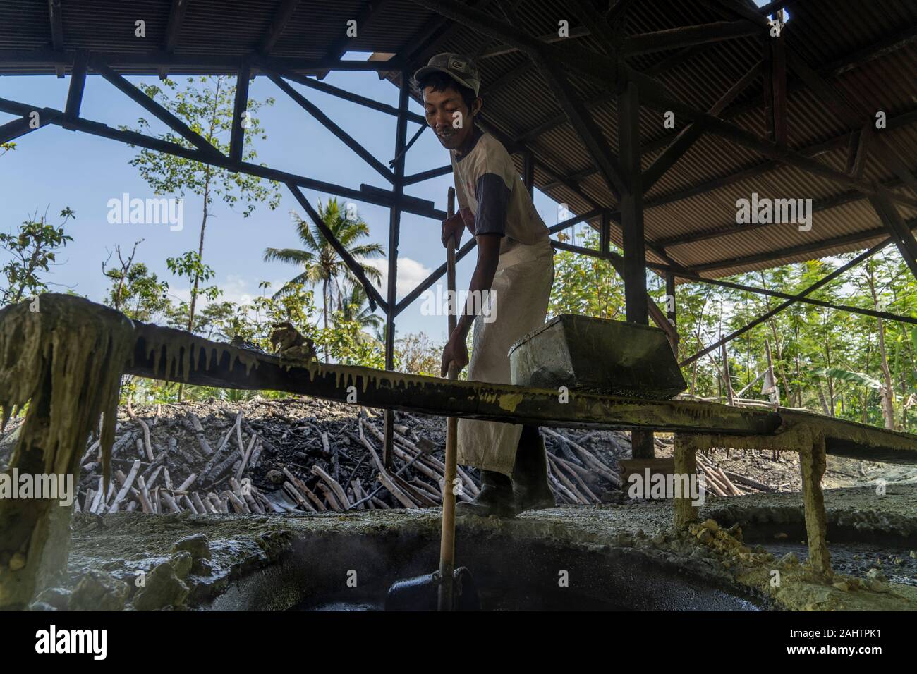 Liquid sulphur is poured through a filter in a sulphur factory deep in ...