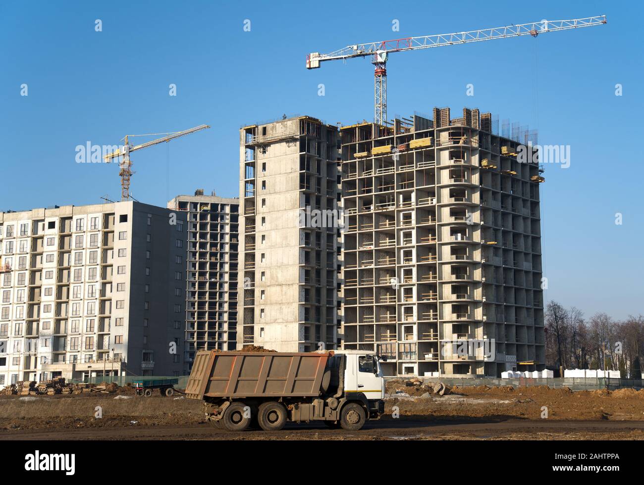Hydraulic luffing jib tower cranes and workers being poured concrete ...