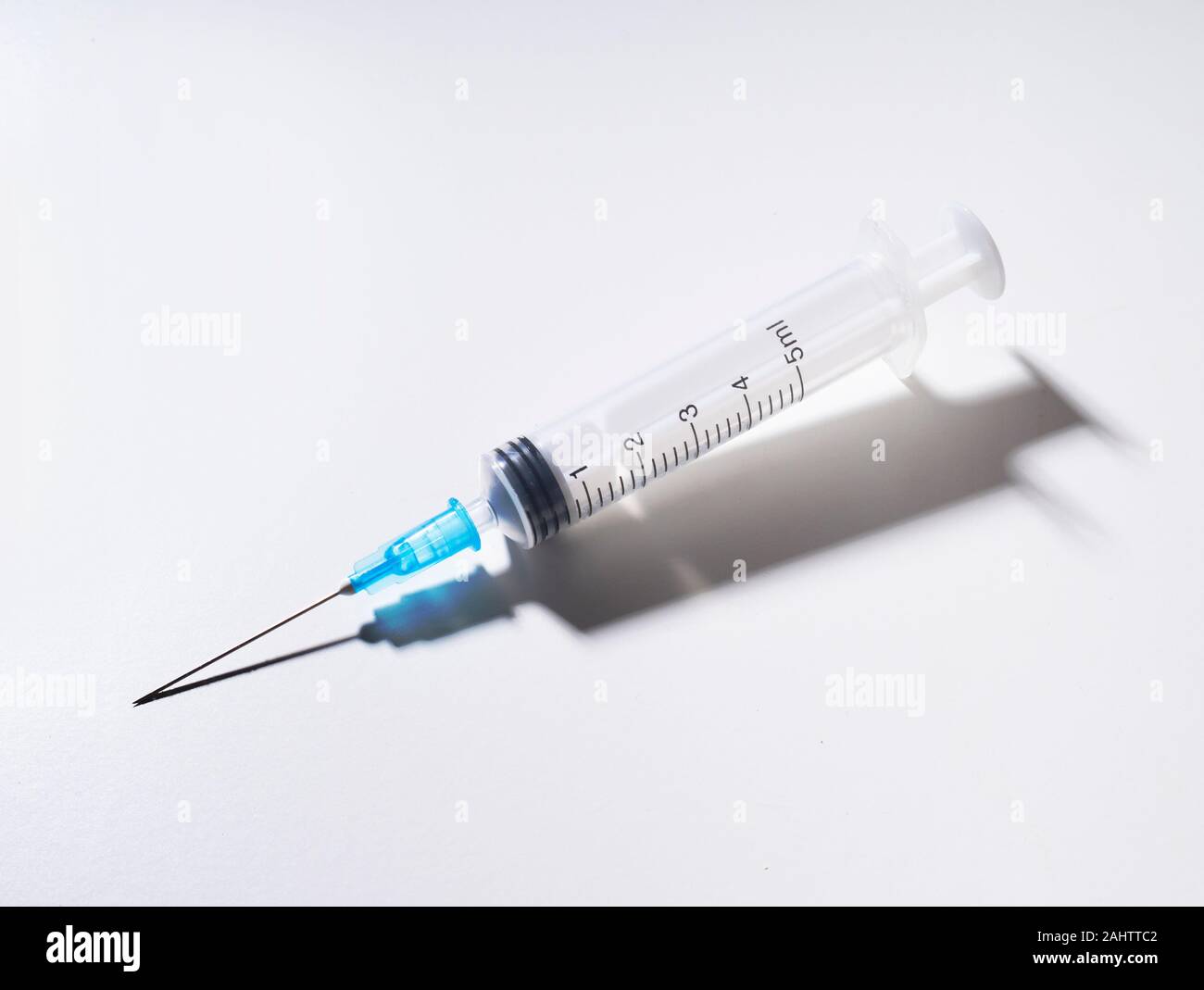 Generic, standard design single use plastic syringe with shadow due to ...