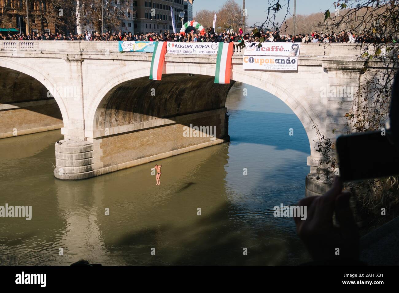 Rome, Italy - Jan 1, 2020: Athlet dives into the Tiber River from the ...