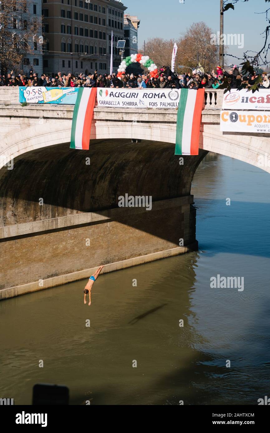 Rome, Italy - Jan 1, 2020: Athlet dives into the Tiber River from the ...