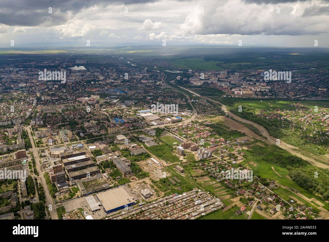 Aerial view of town or city with rows of buildings and curvy streets in ...