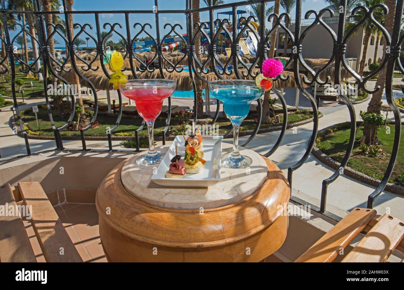 Two cocktail drinks and canapes on table of balcony at luxury tropical ...