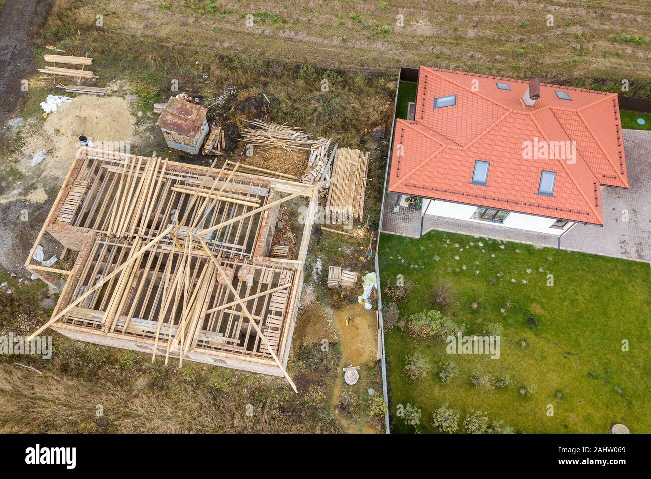 Top down aerial view of two private houses, one under construction with ...