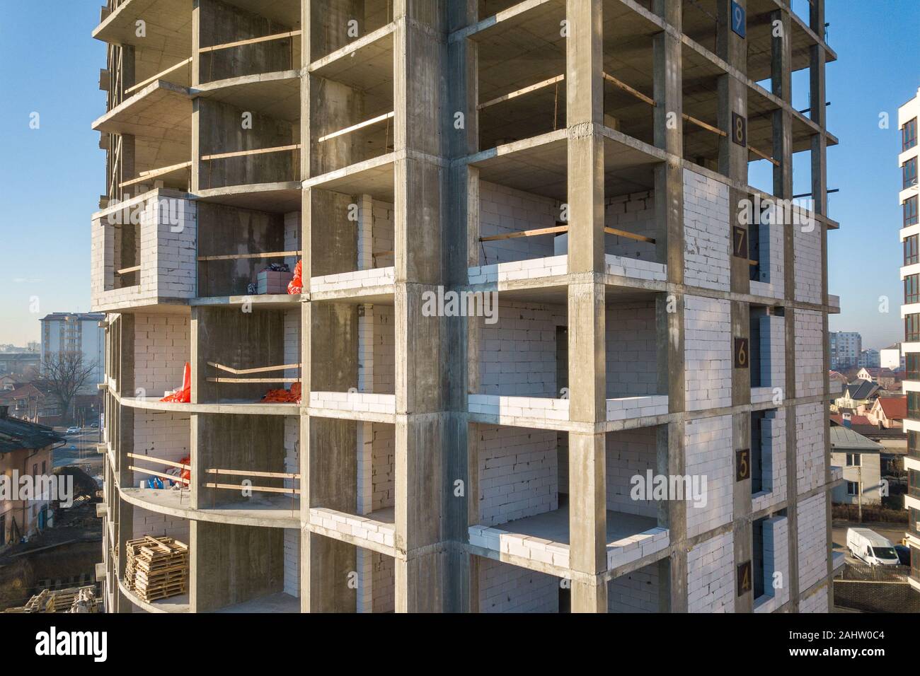 Aerial view of concrete frame of tall apartment building under ...