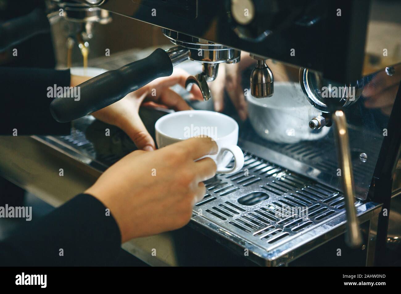 Barista making coffee in a coffee machine Stock Photo - Alamy