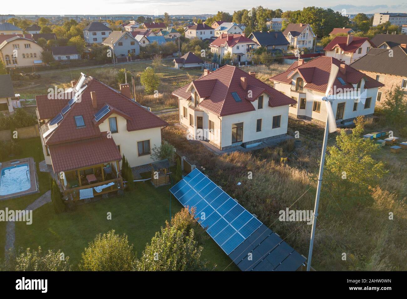 Aerial view of a residential private house with solar panels on roof ...