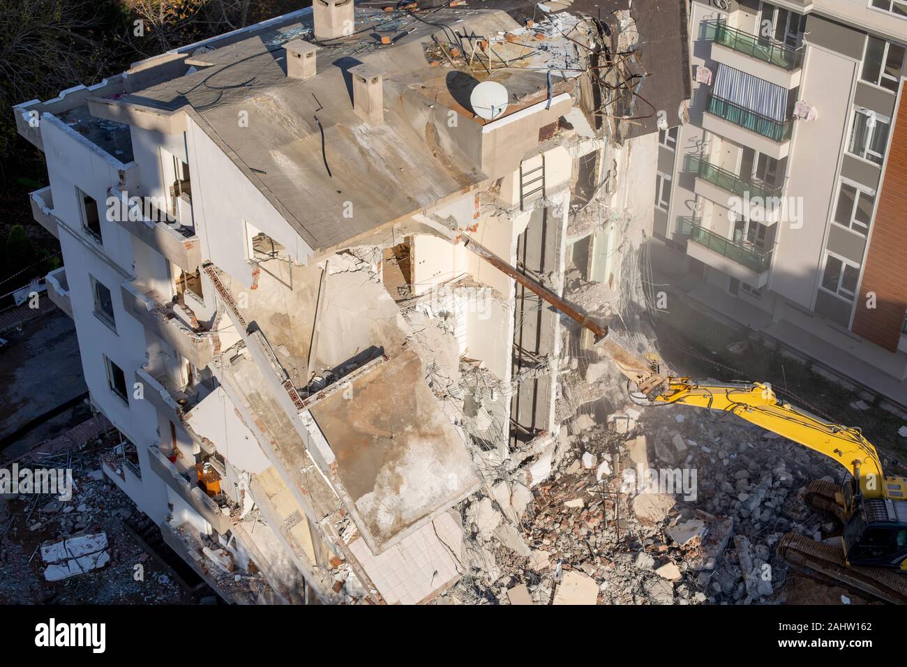 When the work machine was tearing down an apartment building Stock ...