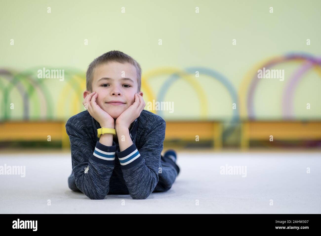 Young child boy laying down and relaxiong while resting on the floor ...