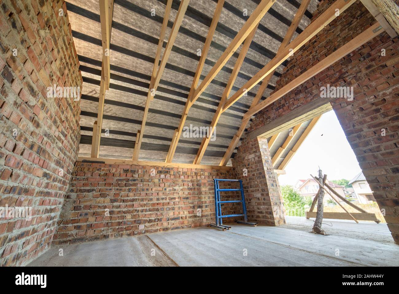 Attic of a building under construction with wooden beams of a roof ...