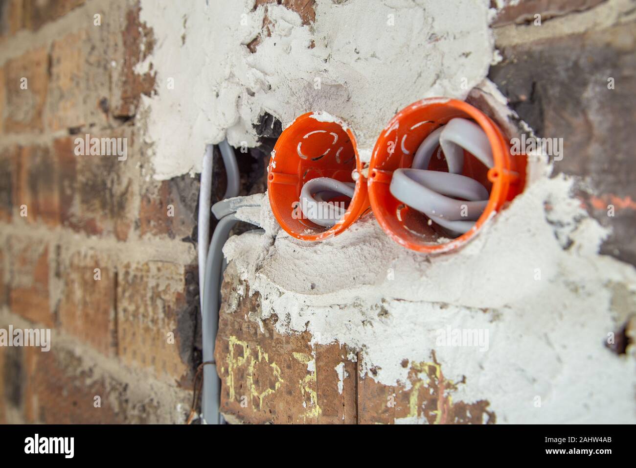 Socket orange boxes with wires in a wall. Cabling installation of ...