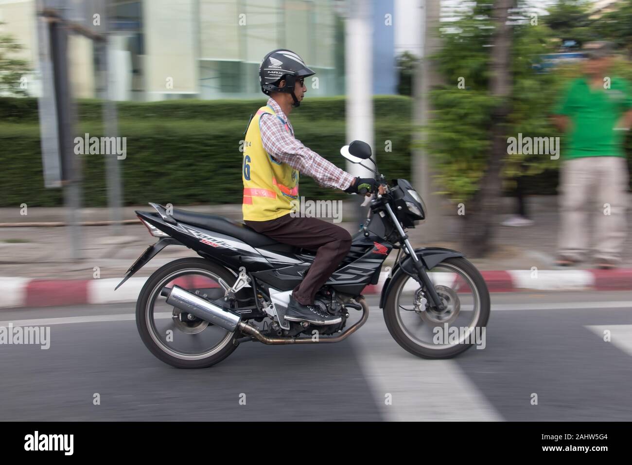 Asian motorcycle taxi man with his motorcycle on the asphalt road Stock ...