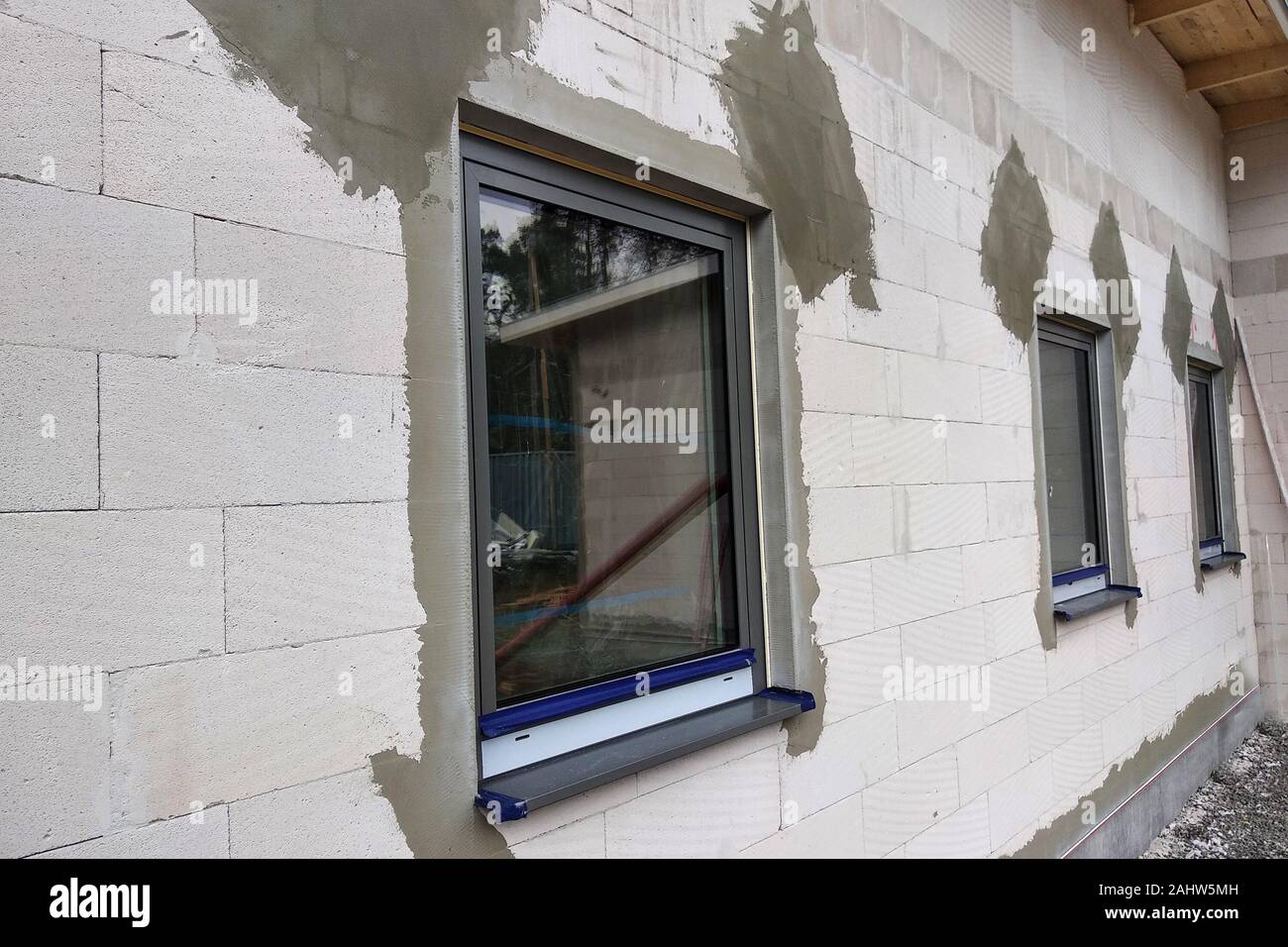 Facade of building made from white blocks with big windows under ...