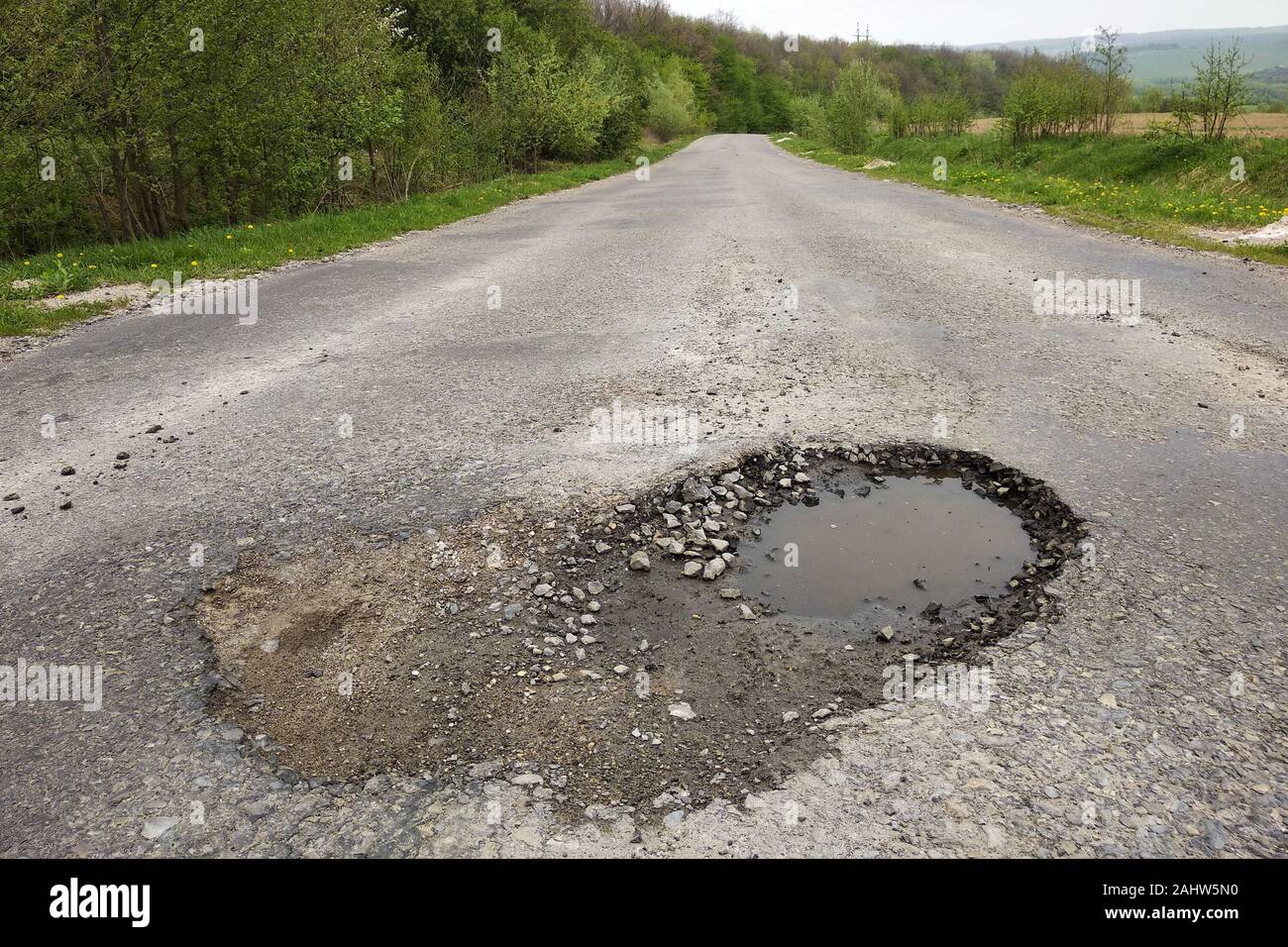 Close up of big pothole with dirty rain water of the road Stock Photo ...