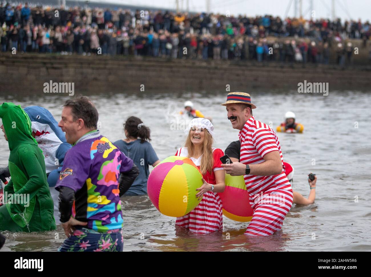 People take part in the Loony Dook New Year's Day dip in the Firth of ...