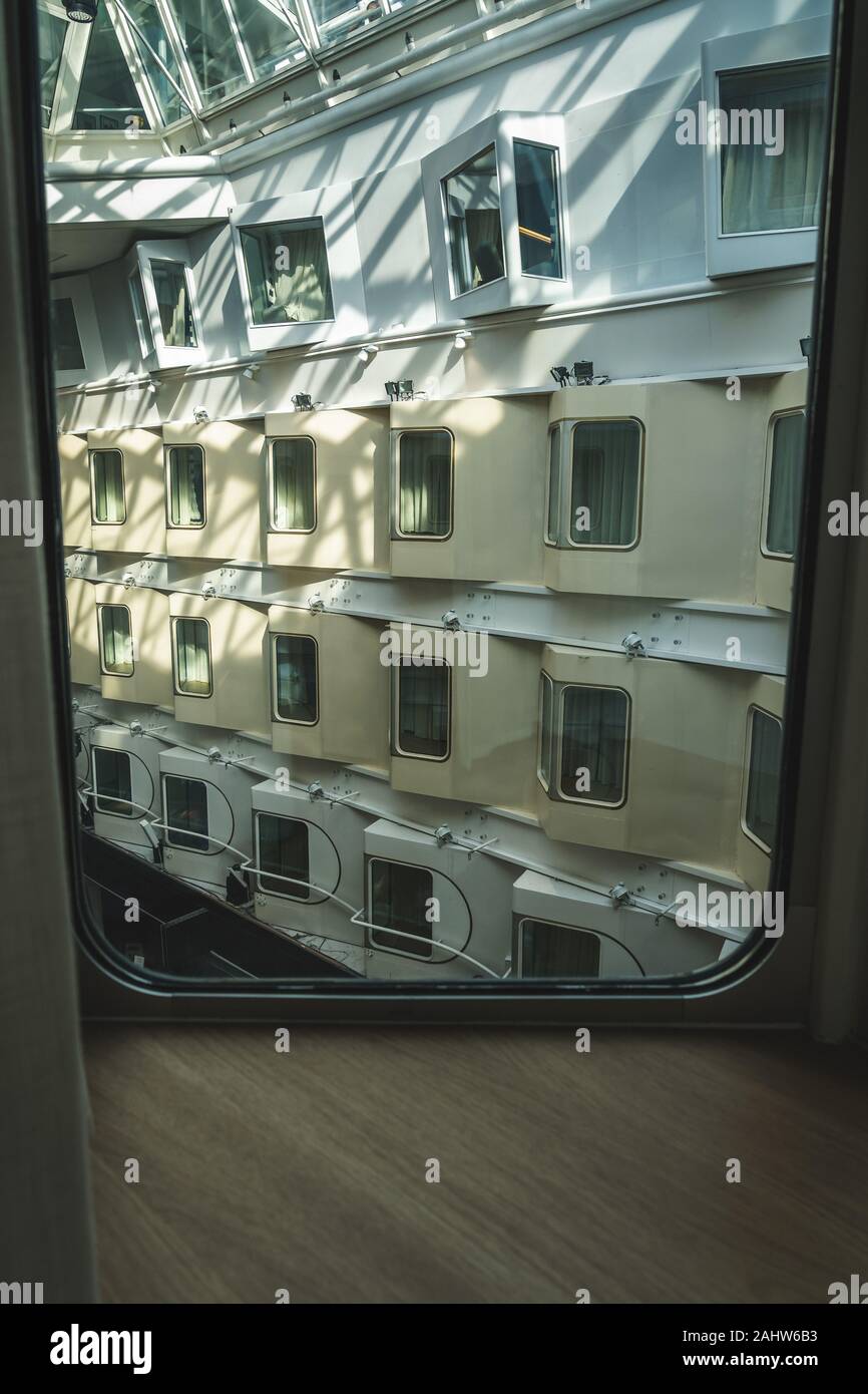 Rows of cabin windows seen on through the window of the other side of ...