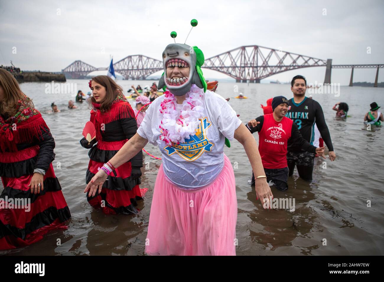 People take part in the Loony Dook New Year's Day dip in the Firth of ...