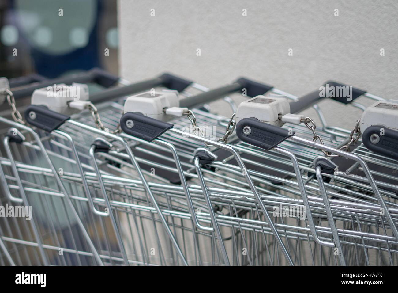 shopping trolleys or shopping carts connected together by payment ...