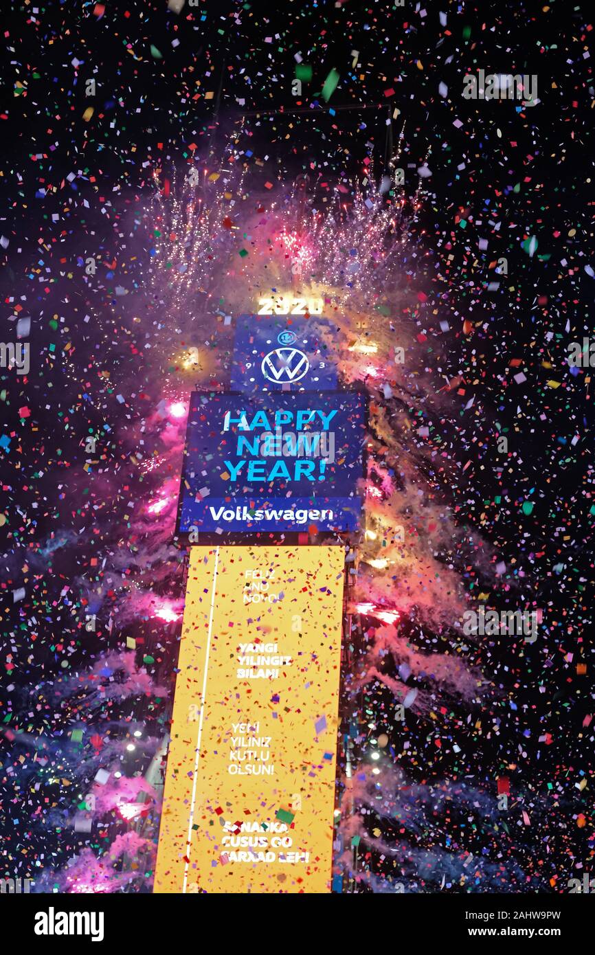 Happy New Year 2020 with fireworks and confetti as the famous ball ...