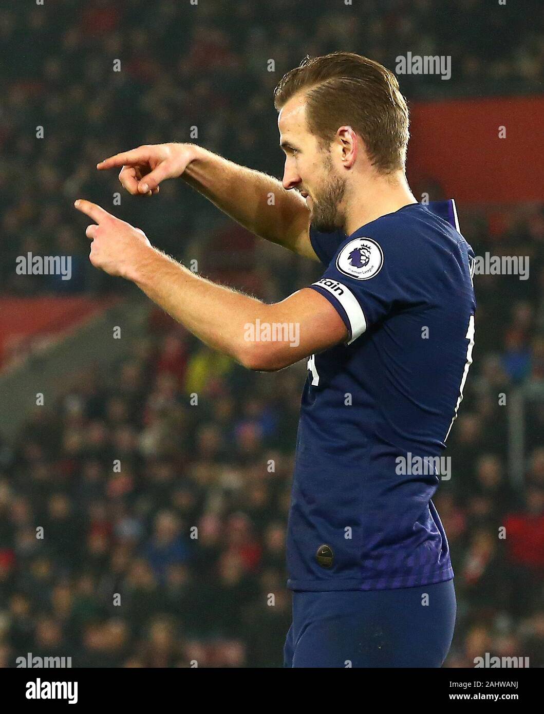 Tottenham Hotspur's Harry Kane indicates to his bench that he has hurt ...