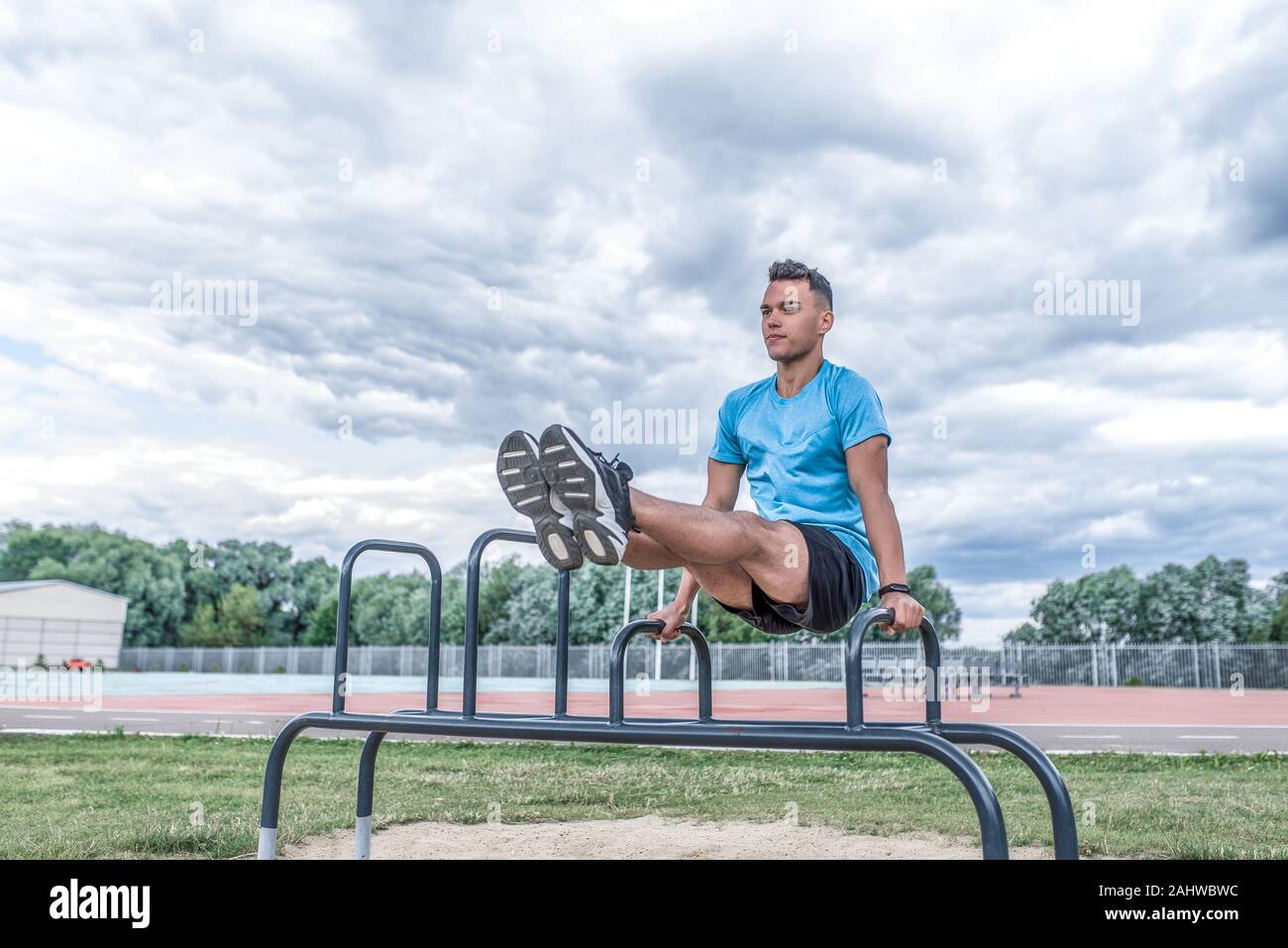 Young sportsman, male athlete, exercise in abdominal muscles, twisting ...