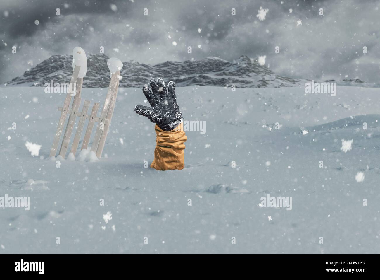 Hiker stretching out his snow covered hand next to wooden sled to ...