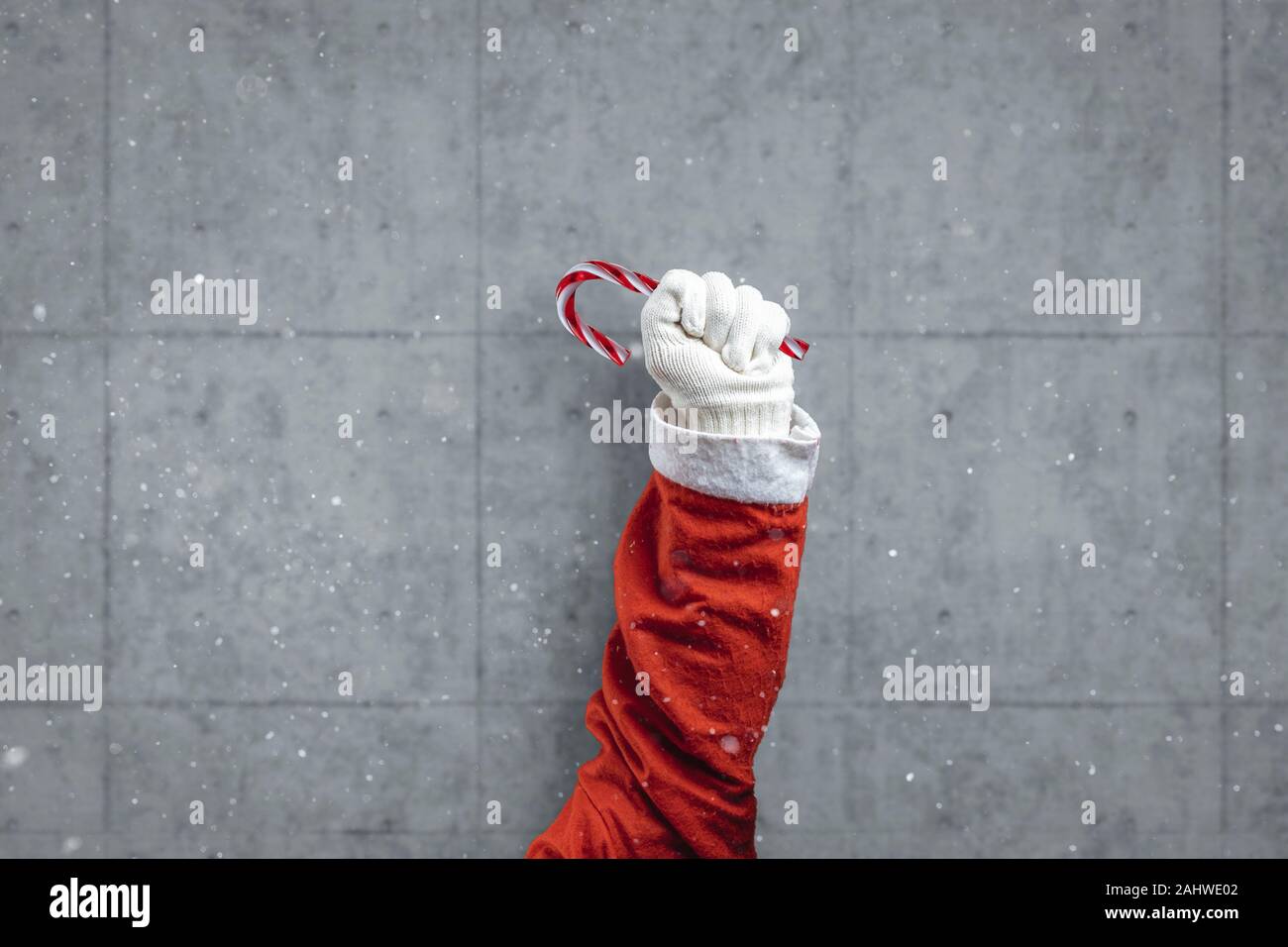 Hand candy cane arm holding hi-res stock photography and images - Alamy