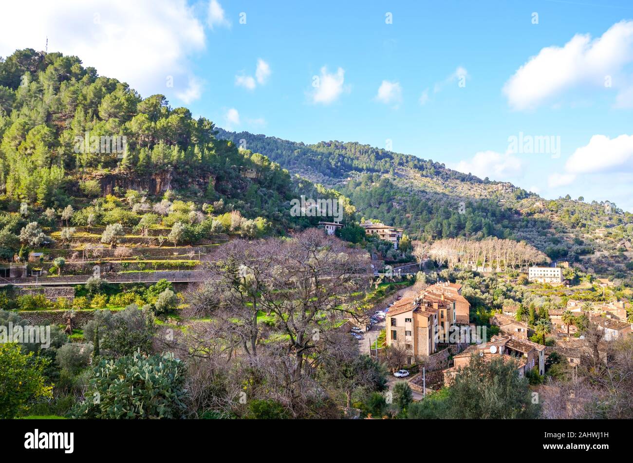 Houses on the green hill in the coastal village Deia in Mallorca, Spain ...
