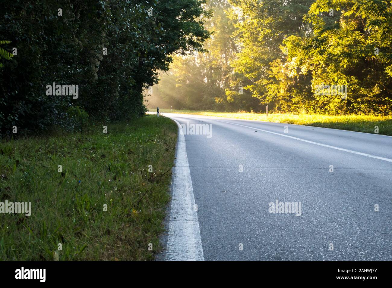 The road, which at the bend is illuminated by sunlight. It represented ...