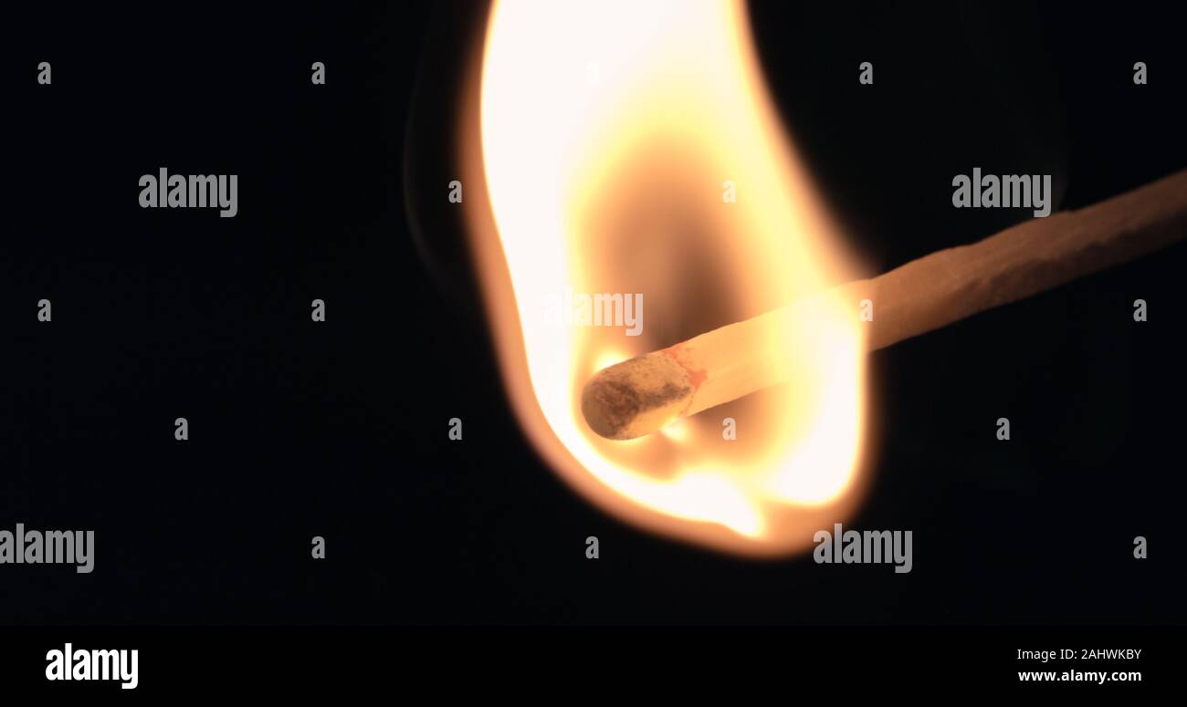 Firing up matches. Ignition lose-up detail of on matchbox and showing ...