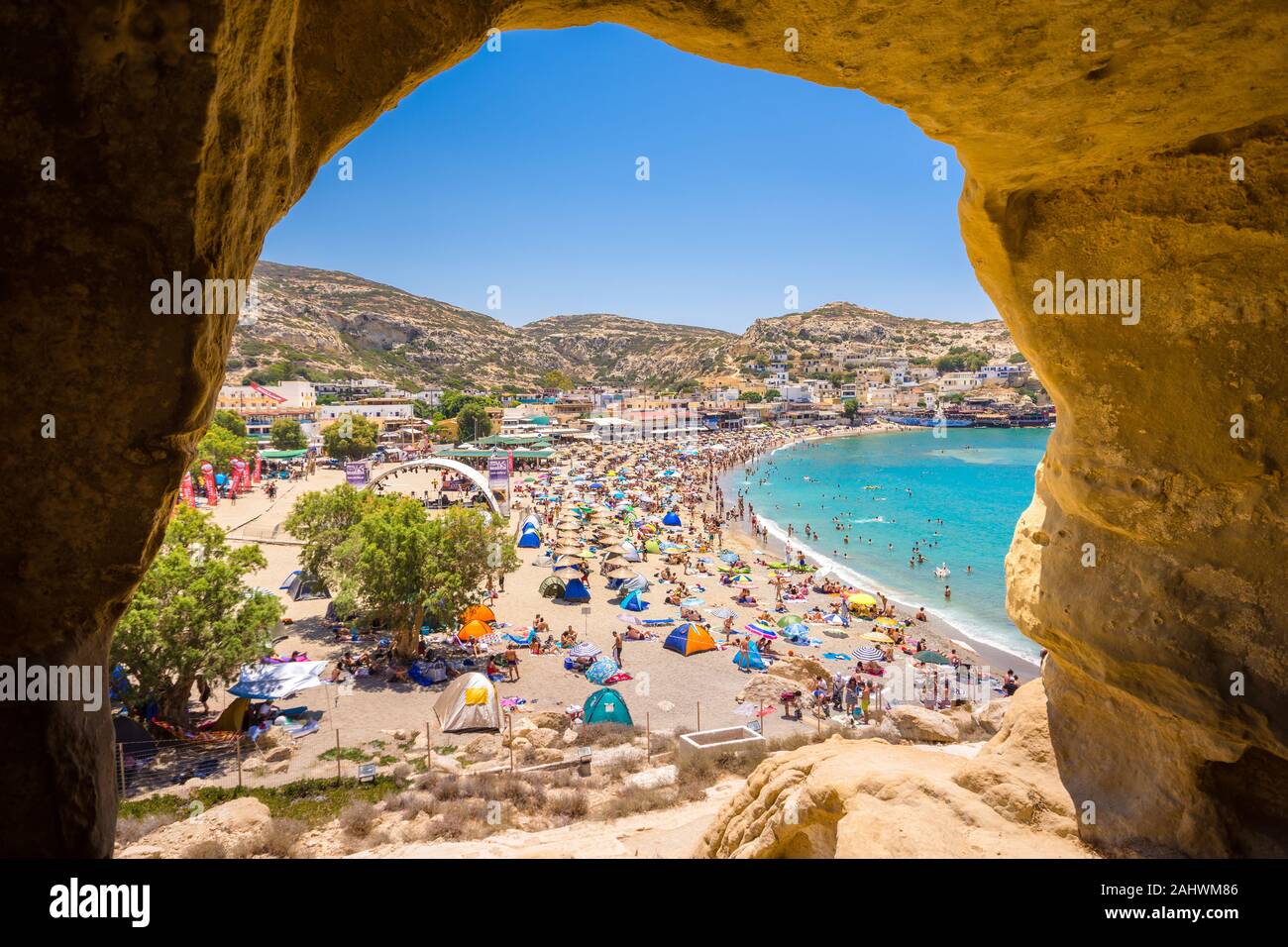 Matala beach with caves on the rocks that were used as a roman cemetery ...