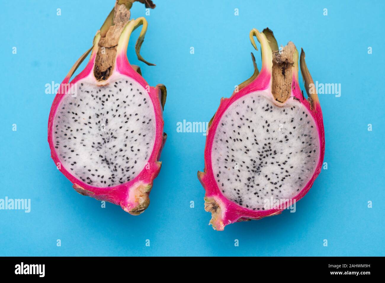 Exotic dragon fruits on blue background, macro. Section of a ripe ...