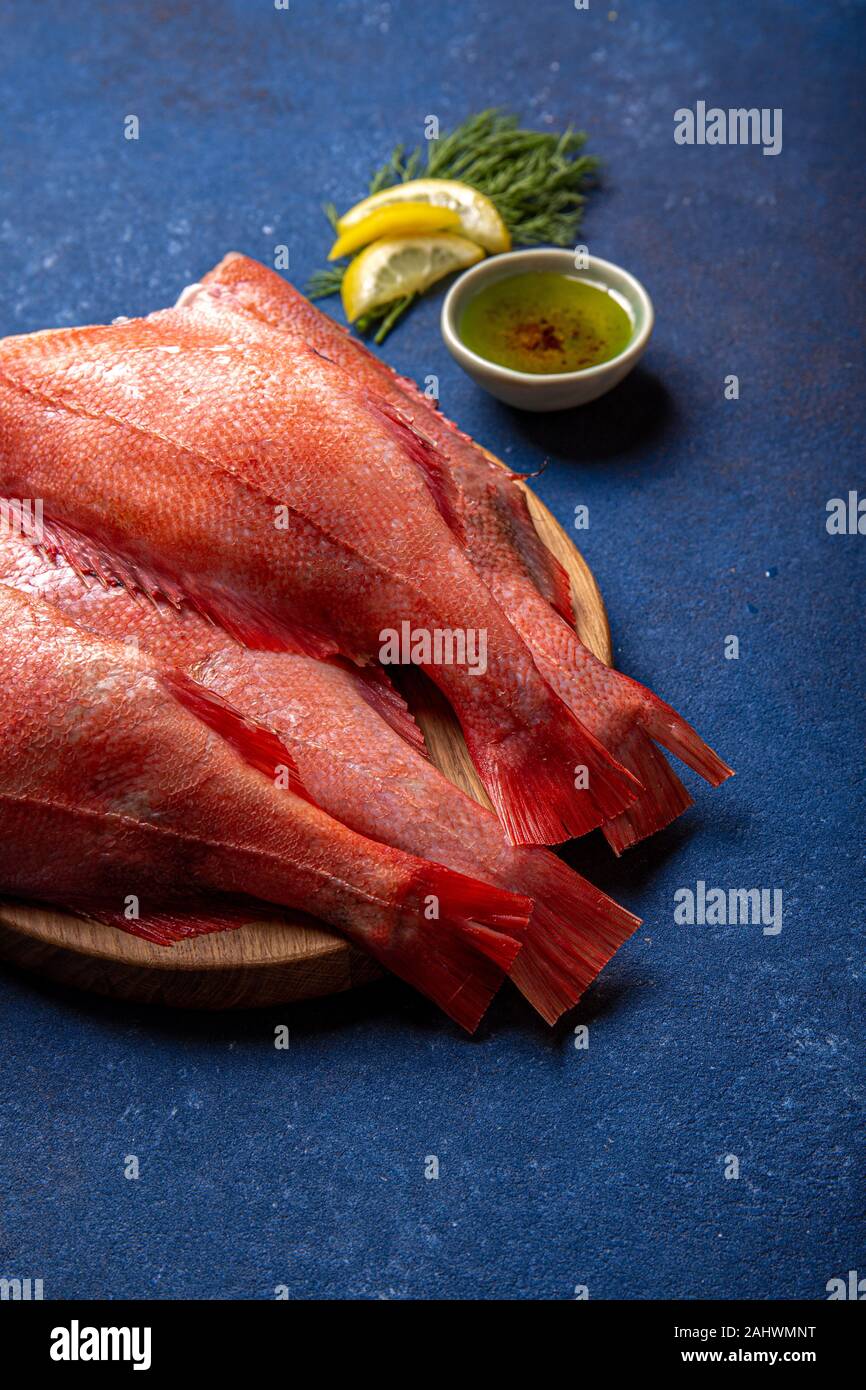 Fresh red sea bass on blue background. Top view, copy space Stock Photo ...