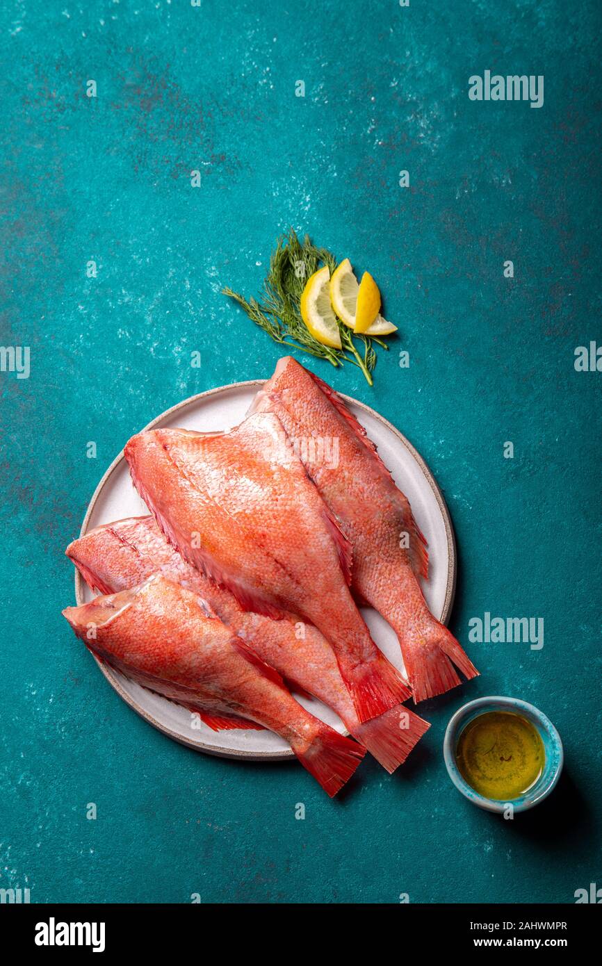 Fresh red sea bass on blue background. Top view, copy space Stock Photo ...
