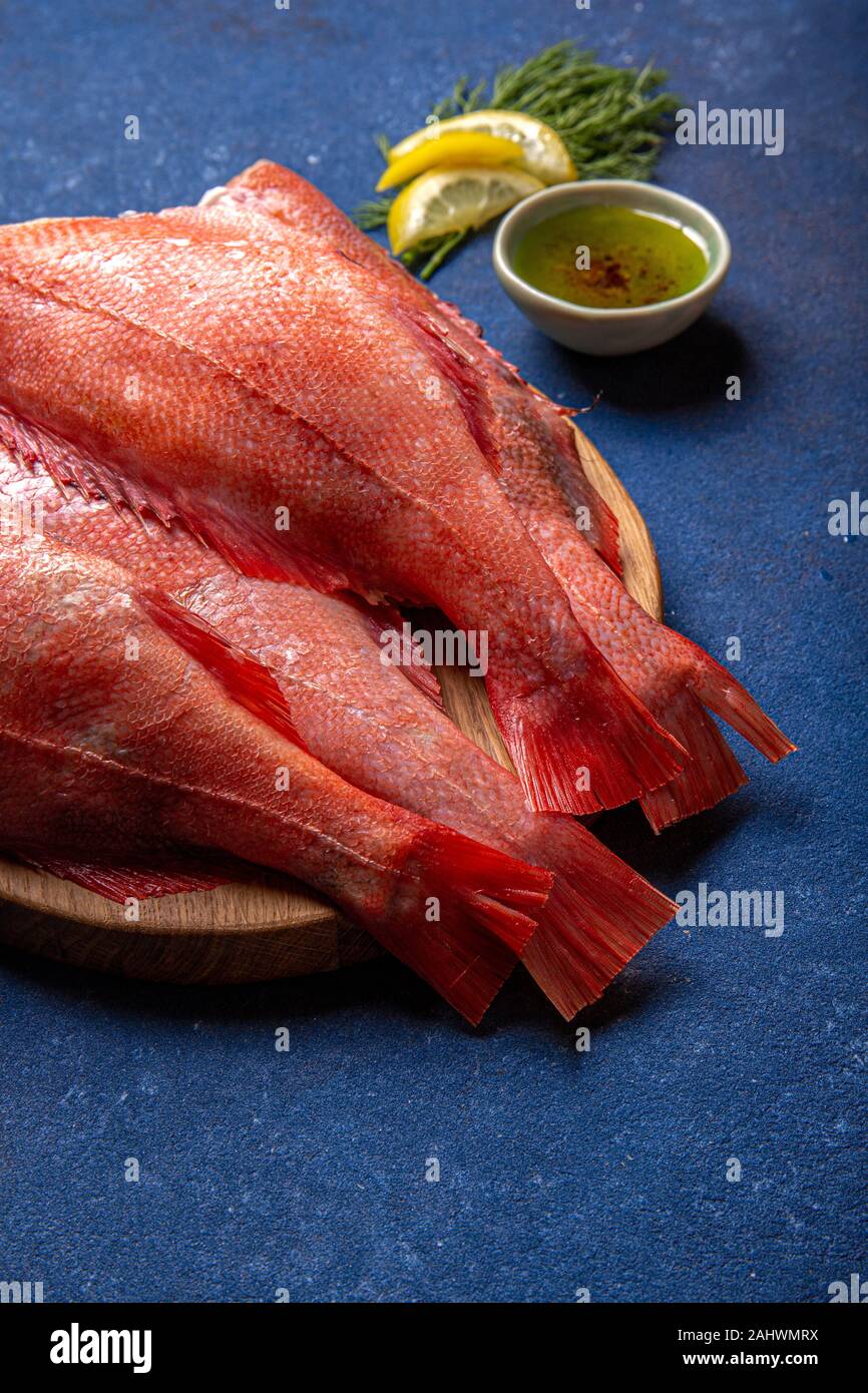 Fresh red sea bass on blue background. Top view, copy space Stock Photo ...
